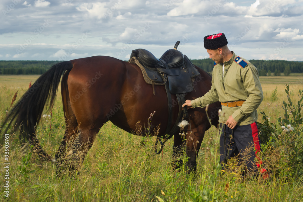 Russian Cossack with a horse resting in the summer field Stock Photo ...