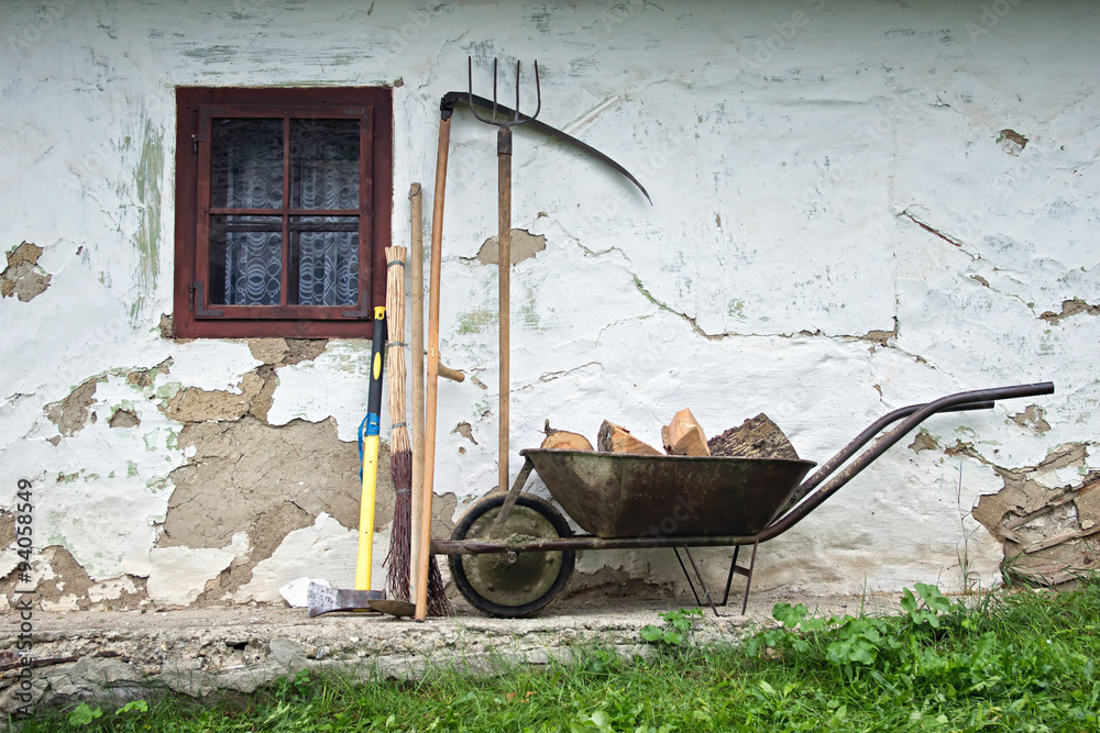 Whell Barrow with Wood and Traditional Mow in Front of Farmhouse Stock ...