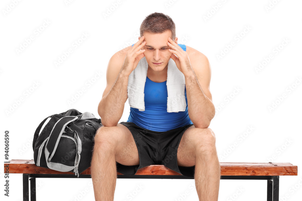 Sad athlete sitting on a bench Stock Photo | Adobe Stock