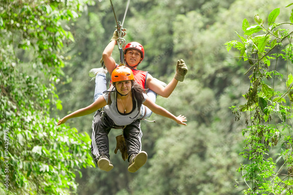 zip line couple hispanic outdoors zipline jungle adventure rain wire ...