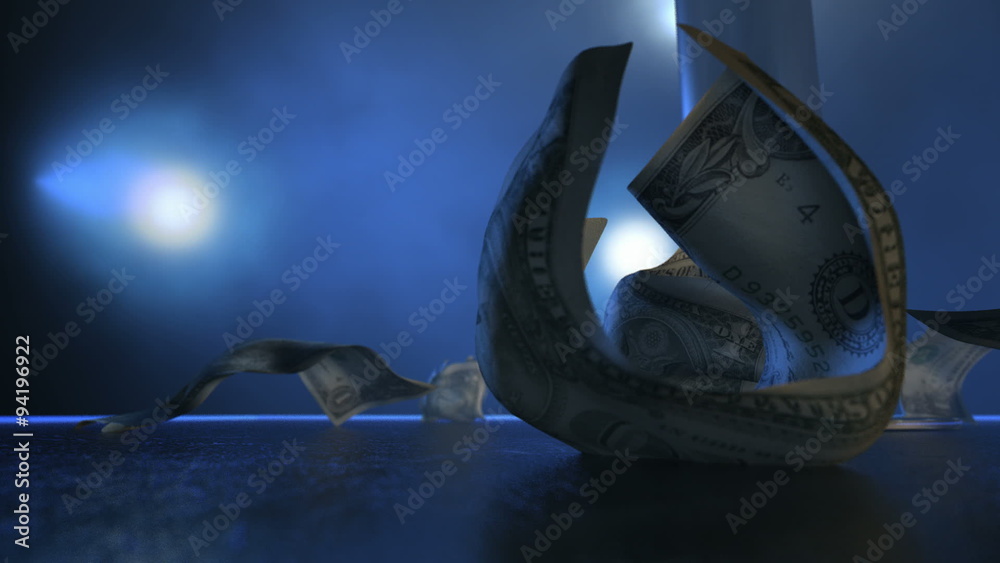 An slow pan across an isolated stripper pole on a stage lit by ...