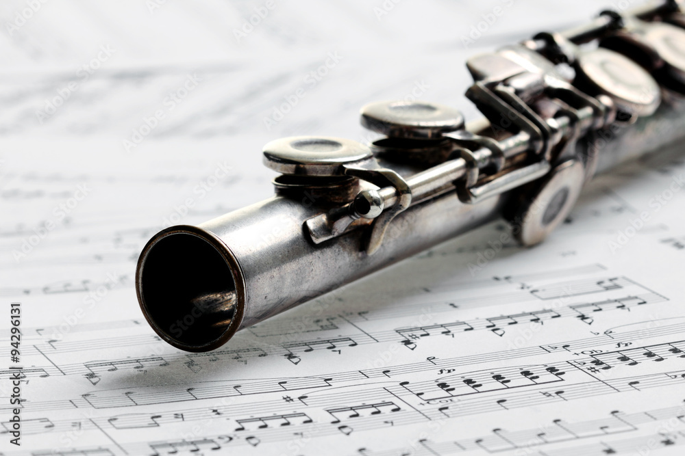 Old rusty silver flute on music notes Stock Photo | Adobe Stock