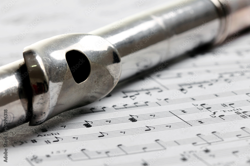 Old rusty silver flute on music notes Stock Photo | Adobe Stock