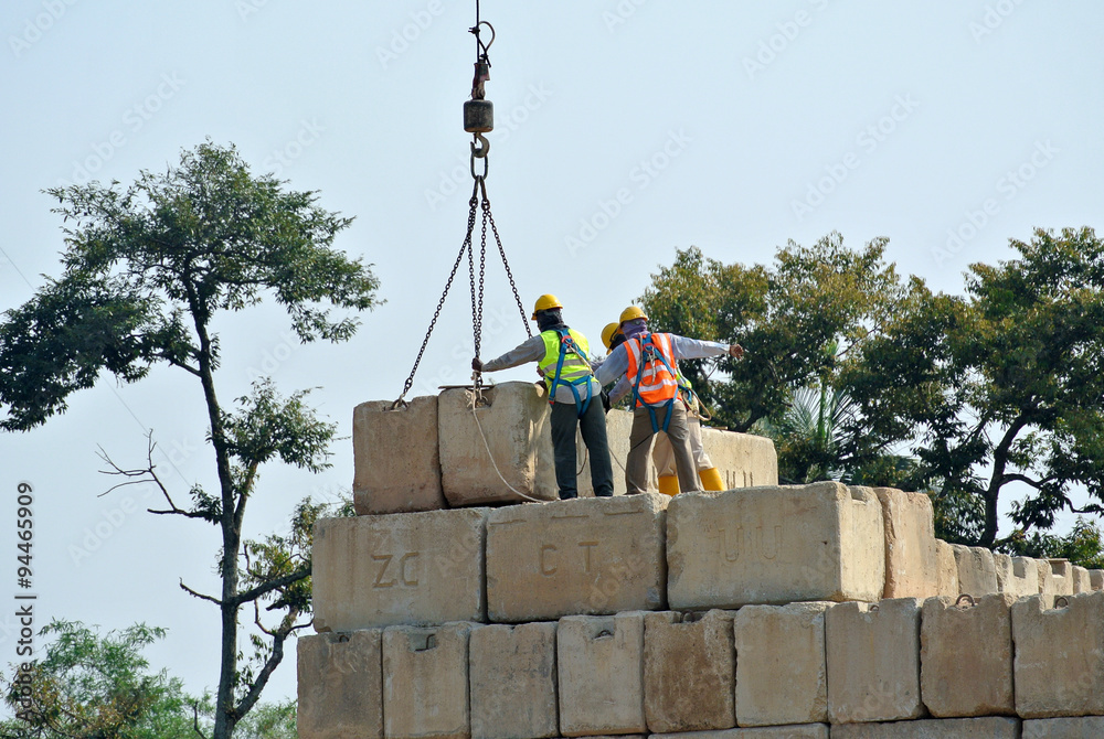 Construction workers stacking the maintain load test block at the ...
