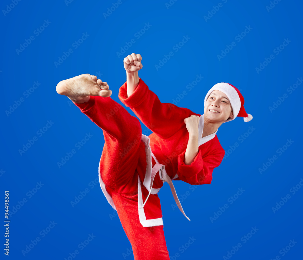 Girl in Santa Claus clothes doing karate techniques Stock Photo | Adobe ...