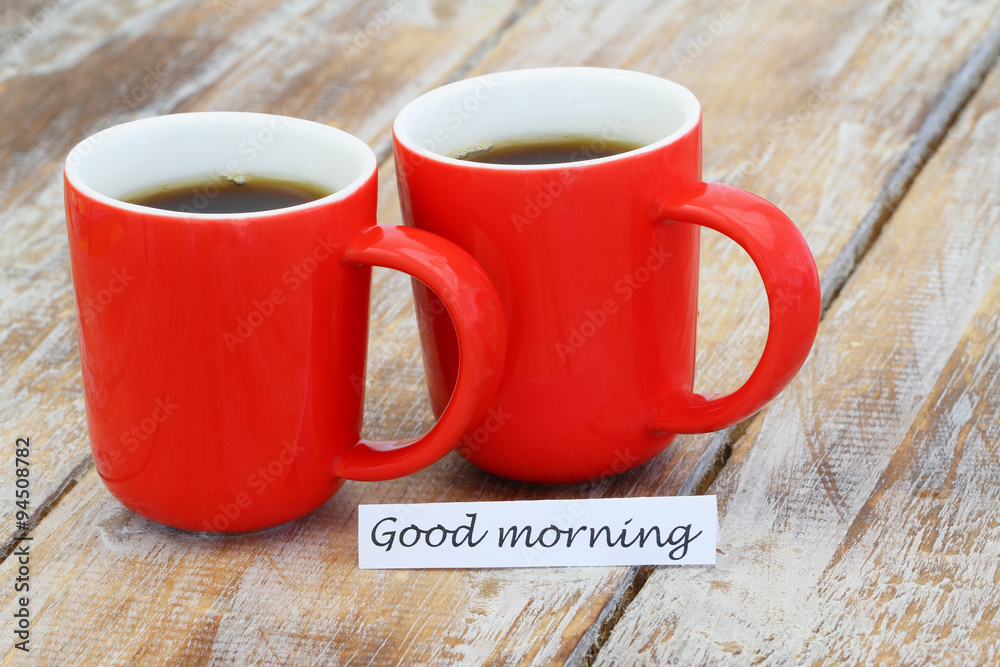 Good morning card with two red coffee mugs on rustic wooden surface ...