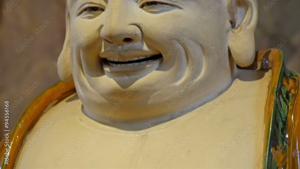 Statue of a bald man with fat face. Showing the smiling fat face of the ...