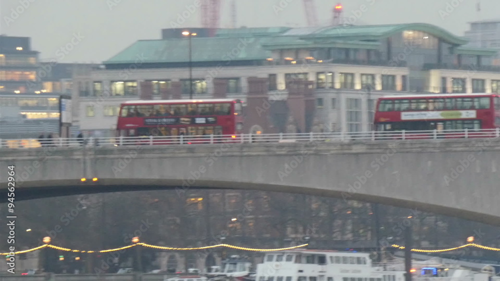 Two London buses on the bridge in London. The bus are running along the ...