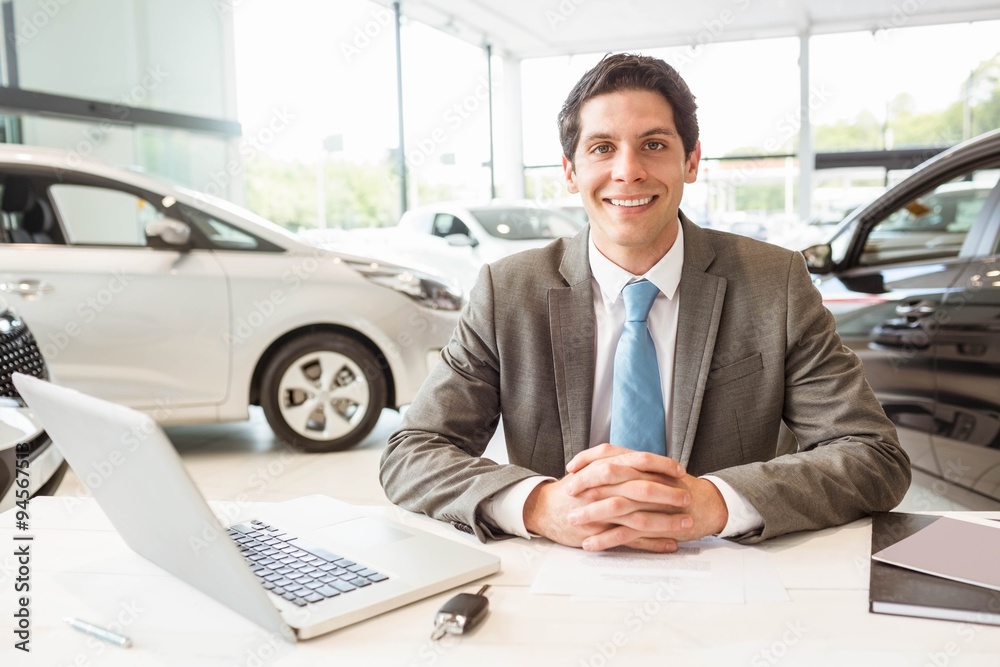 Smiling salesman behind his desk Stock Photo | Adobe Stock