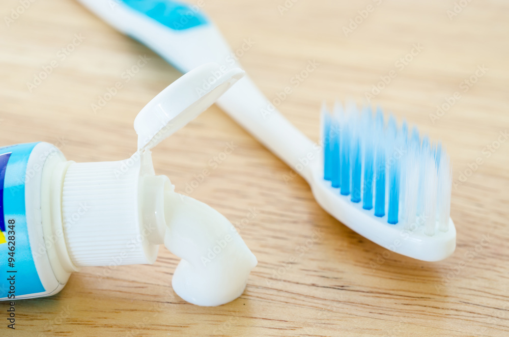 White toothpaste spill out a tube of toothpaste and toothbrush. Stock ...