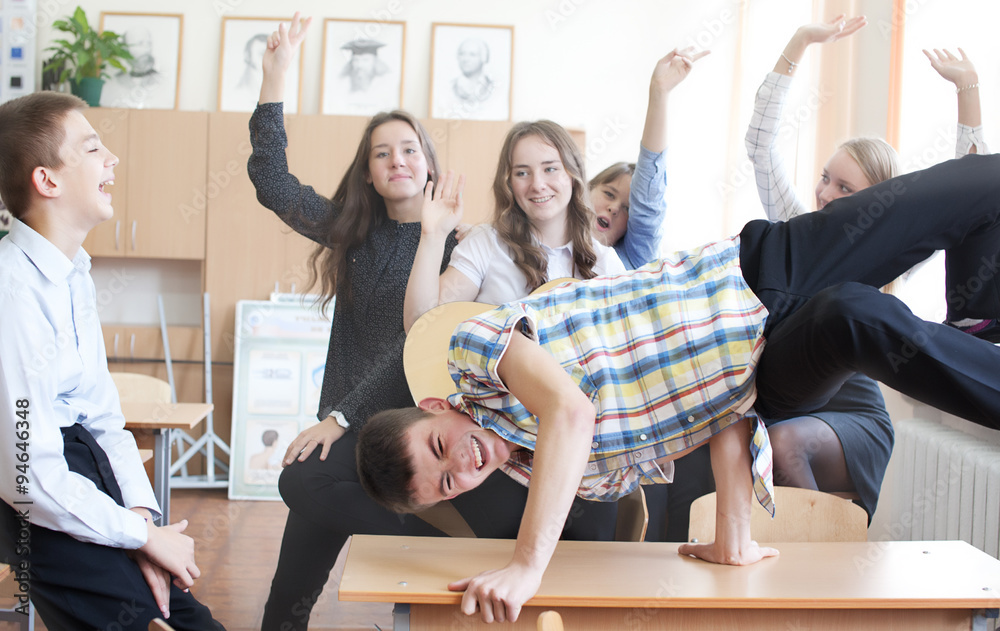 school boy doing back flip on the desk in the classroom . Sunny Stock ...
