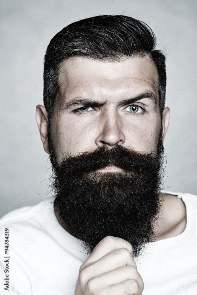 Grey-haired man pulling beard Stock Photo | Adobe Stock