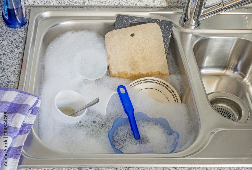 Dirty dishes in soapy water in a kitchen sink Stock Photo | Adobe Stock