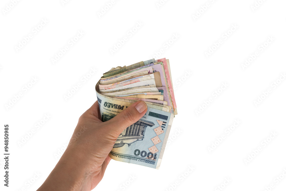 Banknotes from different countries in the hand folded in half isolated ...