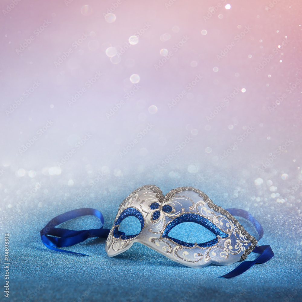 blue female carnival mask and glitter background. with glitter overlay ...