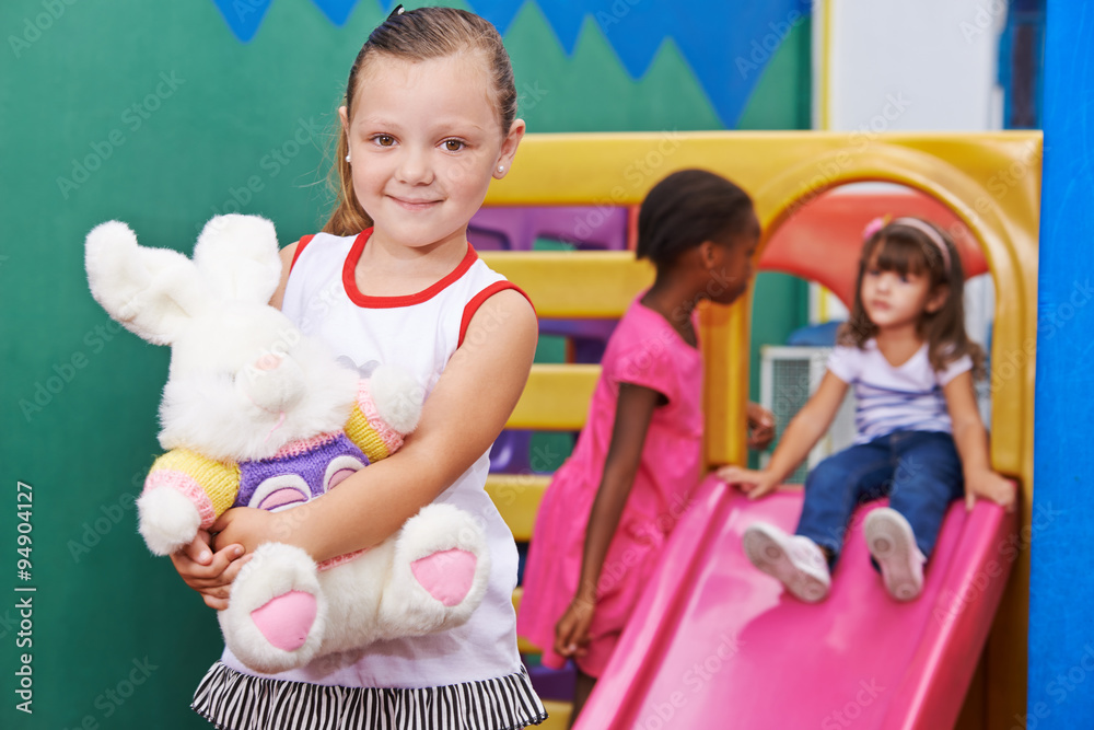Mädchen mit Kuscheltier im Kindergarten Stock Photo | Adobe Stock