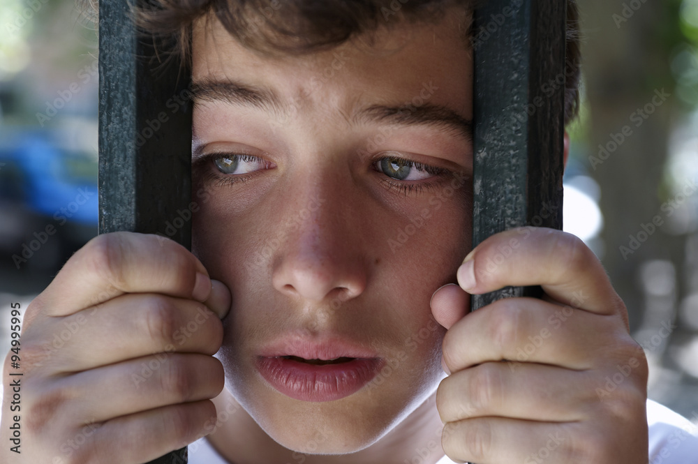 A child crying, behind a fence Stock Photo | Adobe Stock