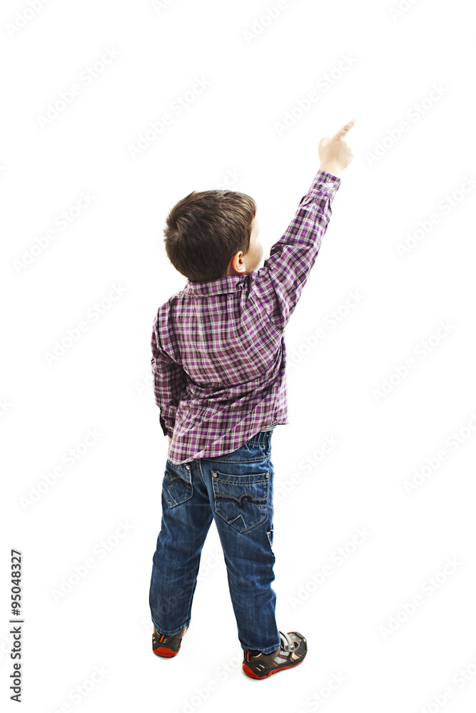 Back view of little boy points at wall. Rear view. Isolated on white ...