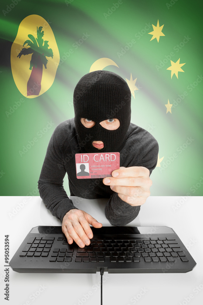 Hacker with flag on background holding ID card in hand - Cocos (Keeling ...