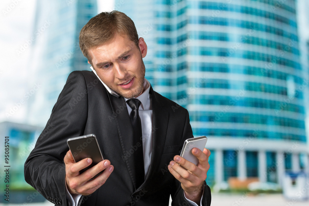 Busy young businessman talking the phone Stock Photo | Adobe Stock