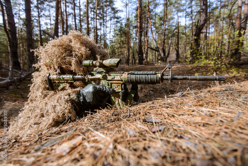 Alone sniper lying in forest/Soldiers clothing as sniper with a rifle ...