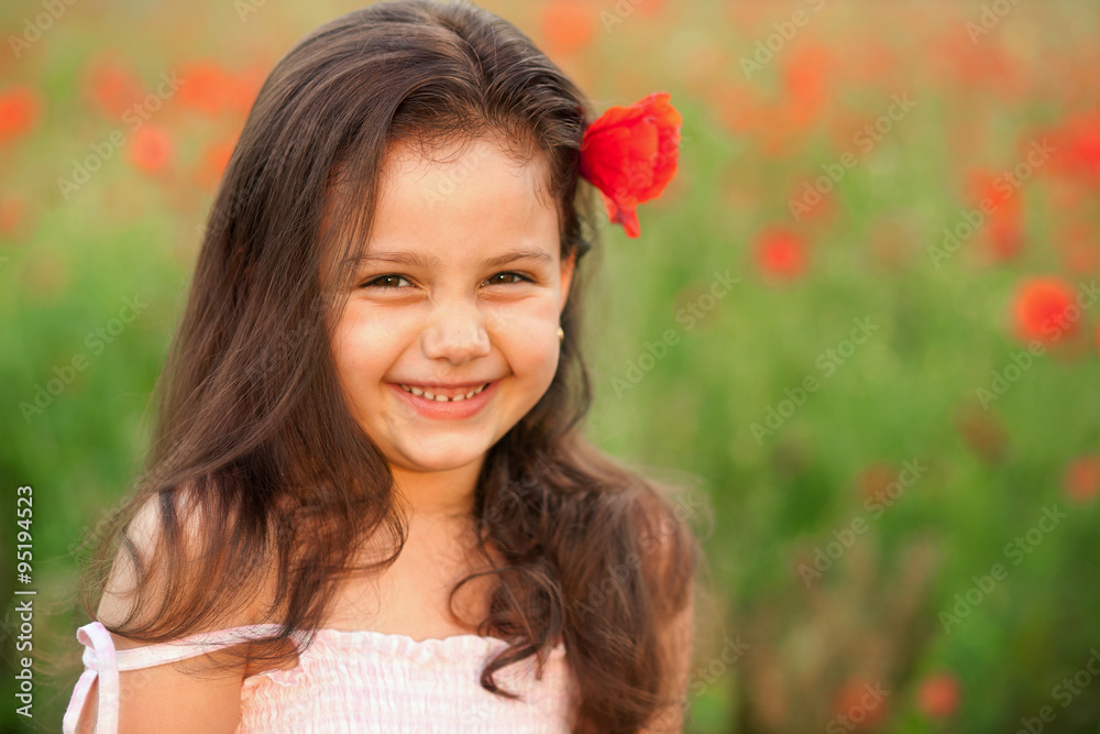 Adorable little girl in poppies. Beautiful smiling child outdoors in a ...