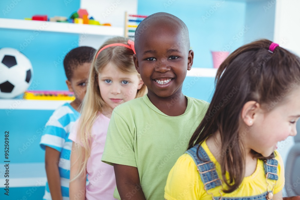 Happy kids standing in a line Stock Photo | Adobe Stock