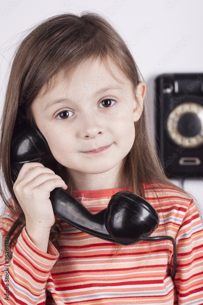 Serious child talking on phone, white background Stock Photo | Adobe Stock