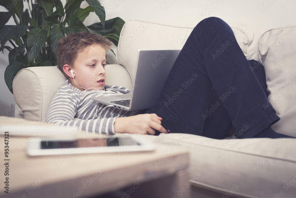 Young boy using a laptop Stock Photo | Adobe Stock