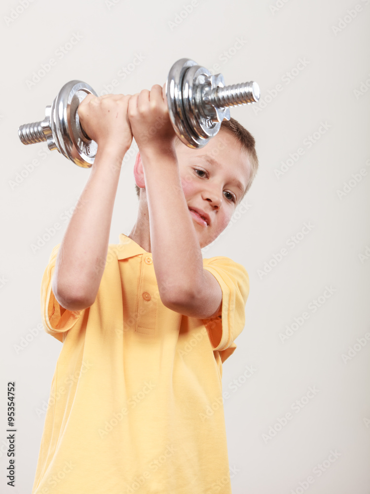 Sports boy making exercise with dumbbell. Stock Photo | Adobe Stock