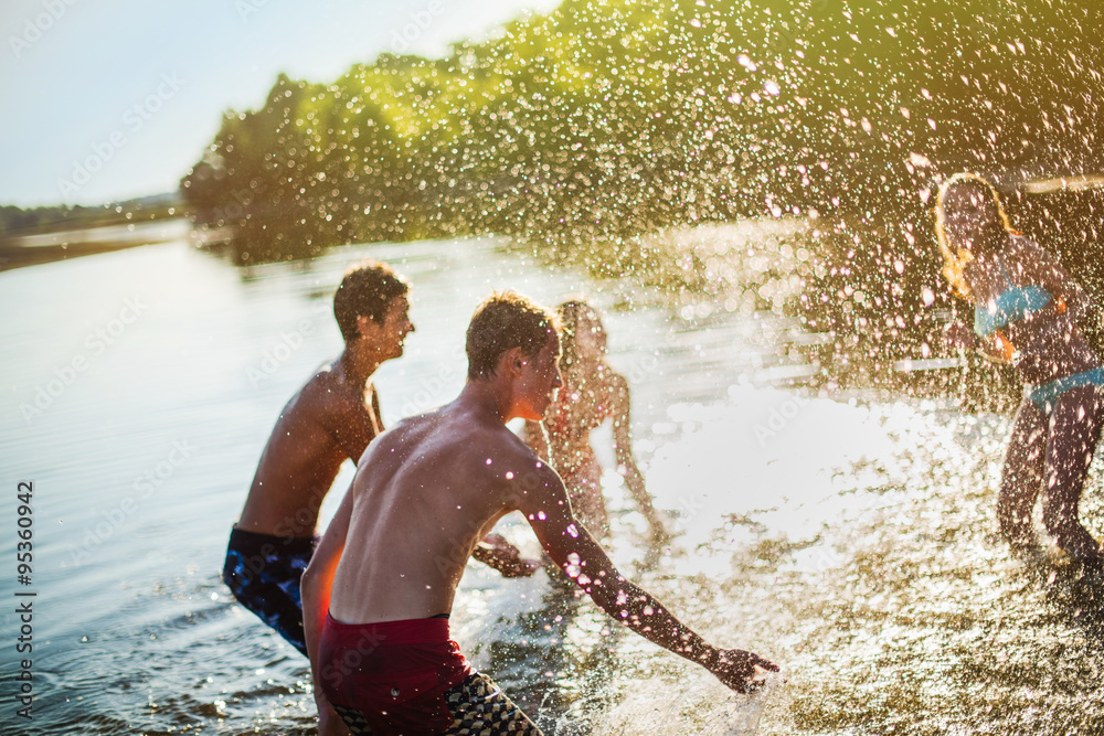 drop of water shining in the sun, teens splashing on the beach Stock ...