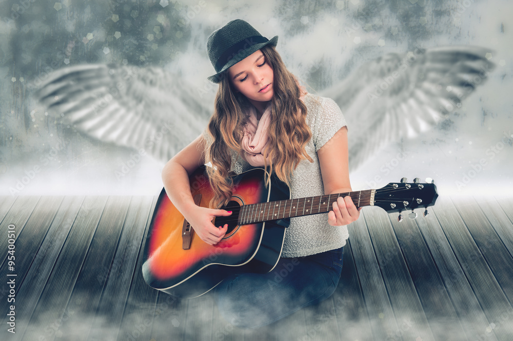 Singing Angel. Portrait of a beautiful girl with a guitar, behind which ...