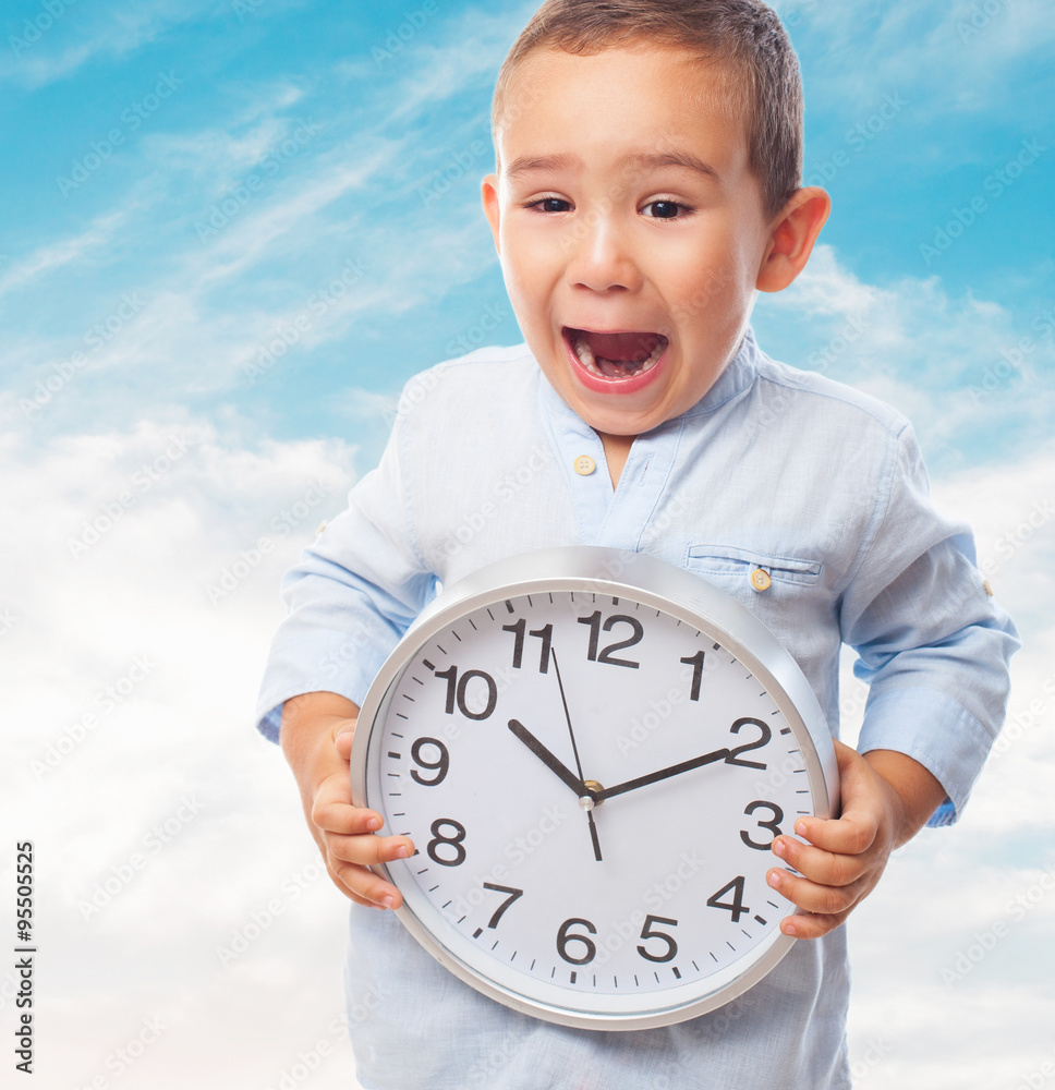 portrait of a little boy holding a clock Stock Photo | Adobe Stock