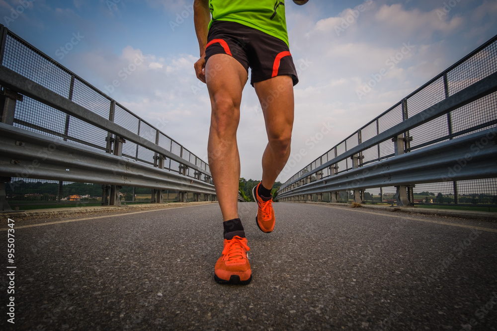 Man running toward camera on a paved road Stock Photo | Adobe Stock