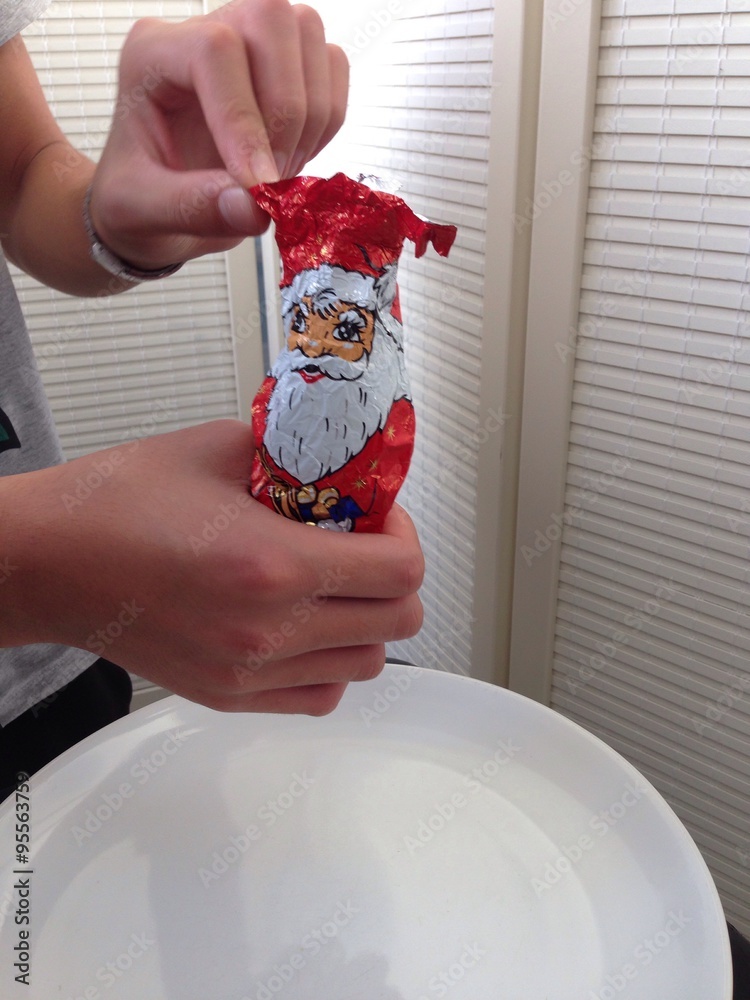 unwrapping a melting chocolate santa Stock Photo | Adobe Stock
