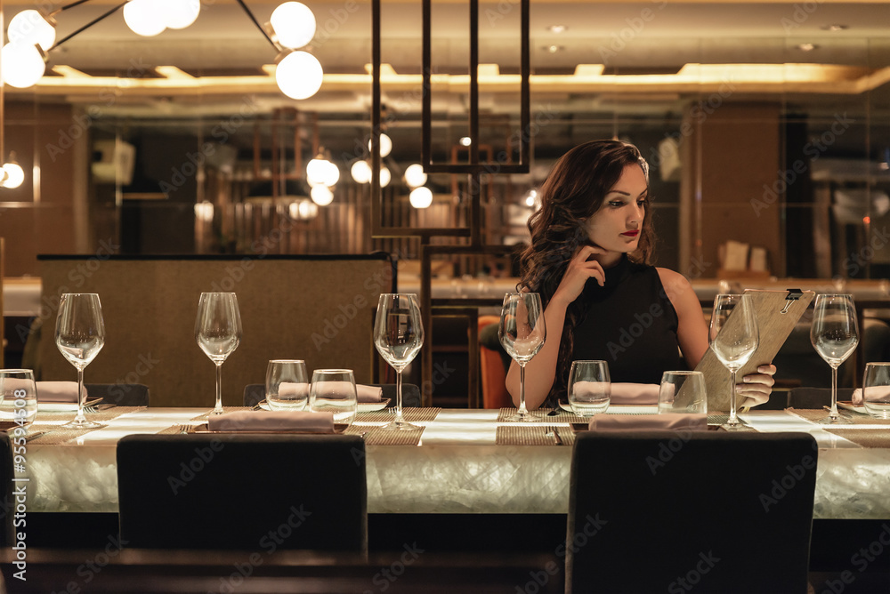 Beautiful young girl in luxury restaurant interior Stock Photo | Adobe ...