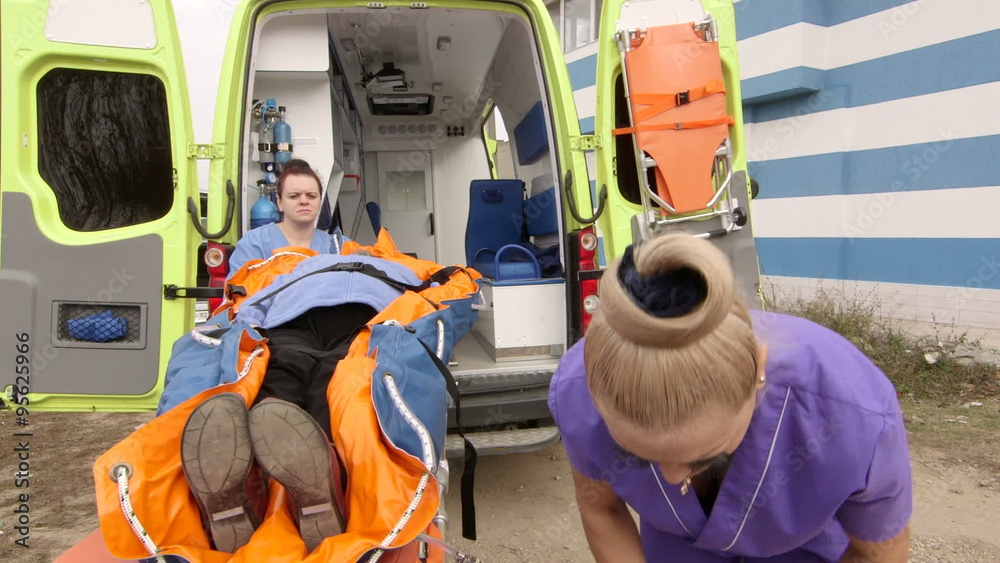 Emergency medical ambulance service paramedics crew fixing senior ...