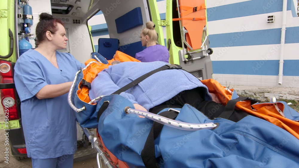 Emergency medical ambulance service paramedics crew fixing senior ...