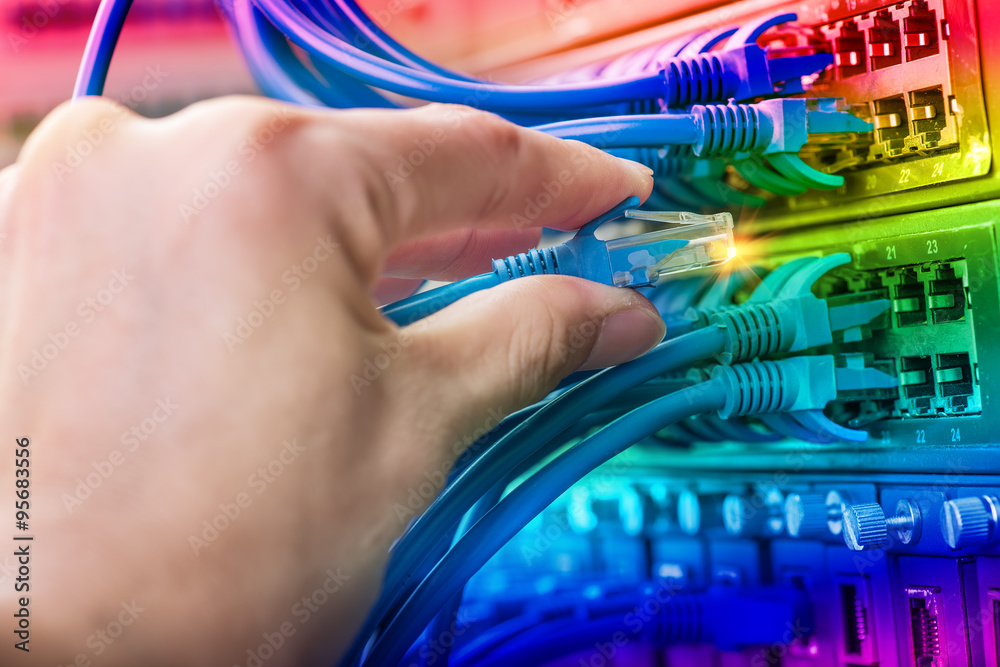 man working in network server room with fiber optic hub for digi Stock ...