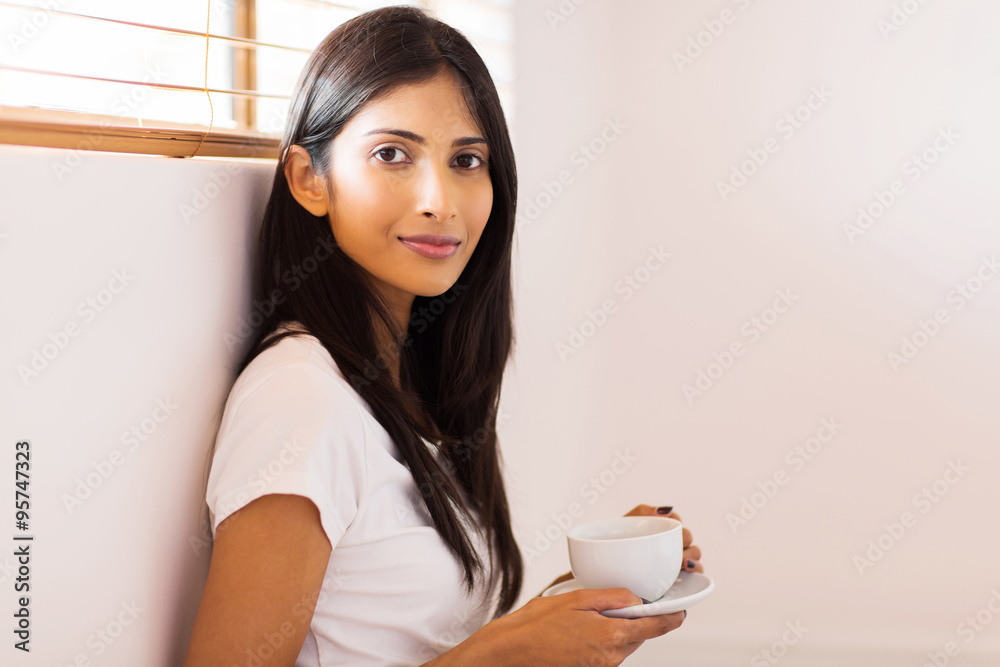 Foto de young indian woman drinking tea do Stock | Adobe Stock