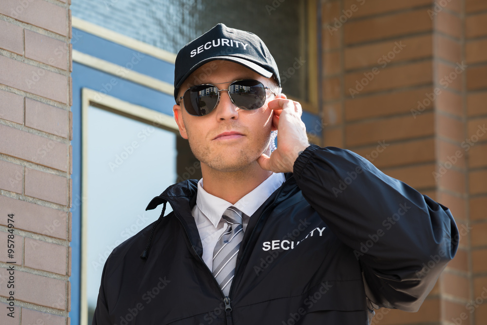 Young Security Guard Standing In Front Of The Entrance Stock-Foto ...