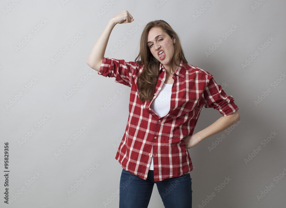 girl power concept - man-like young brunette acting stupid,showing her ...