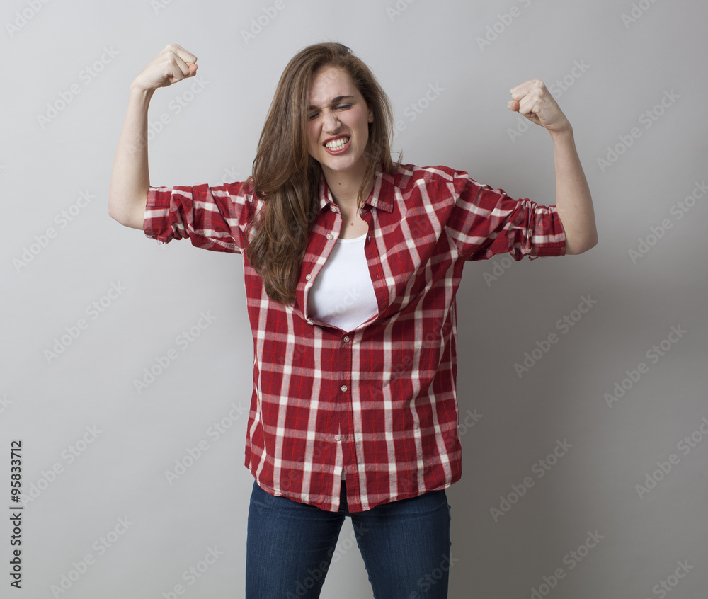 girl power concept - excited beautiful young brunette showing her ...