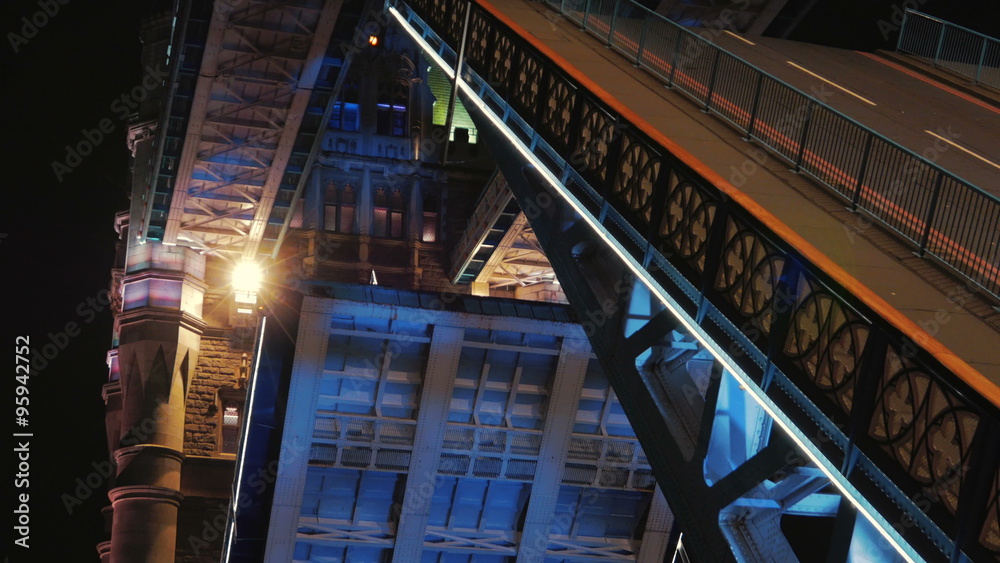 A night ultra close-up view of Tower Bridge's lifts opening. The Tower ...