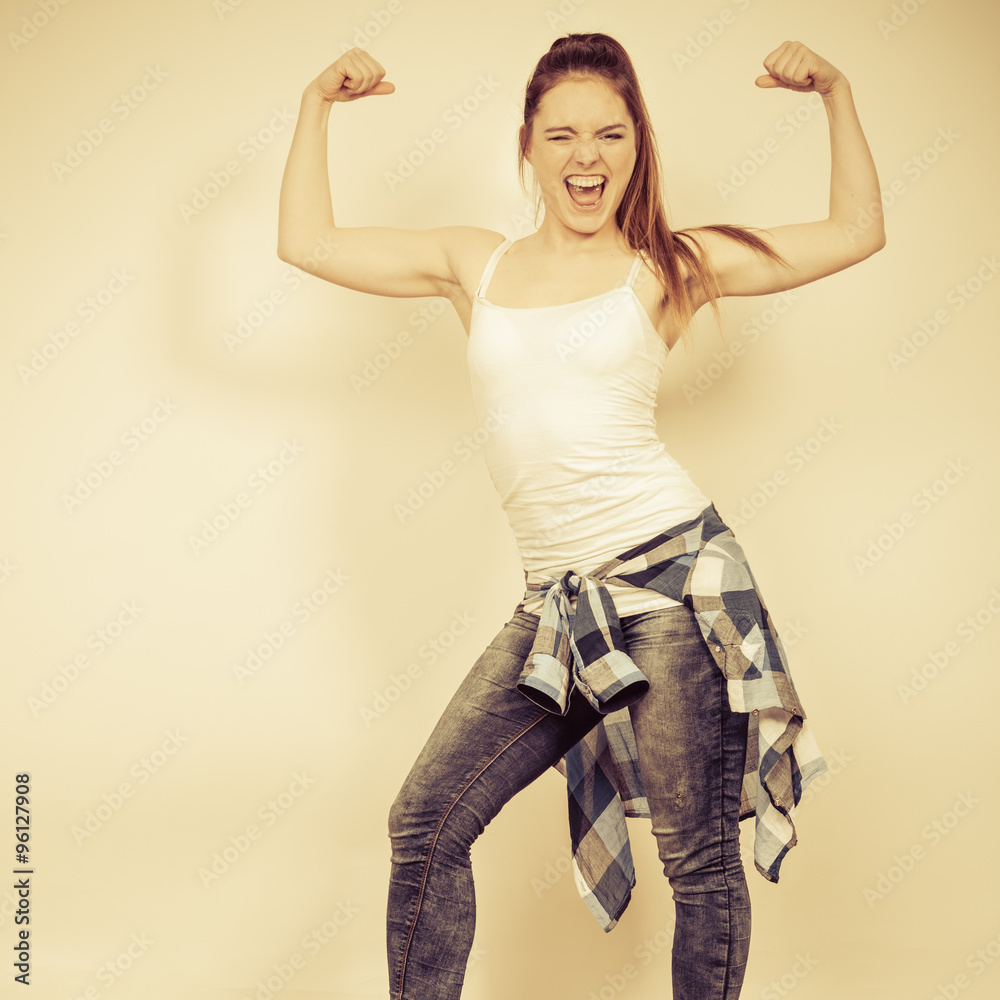 Strong woman showing off muscles. Strength. Stock Photo | Adobe Stock