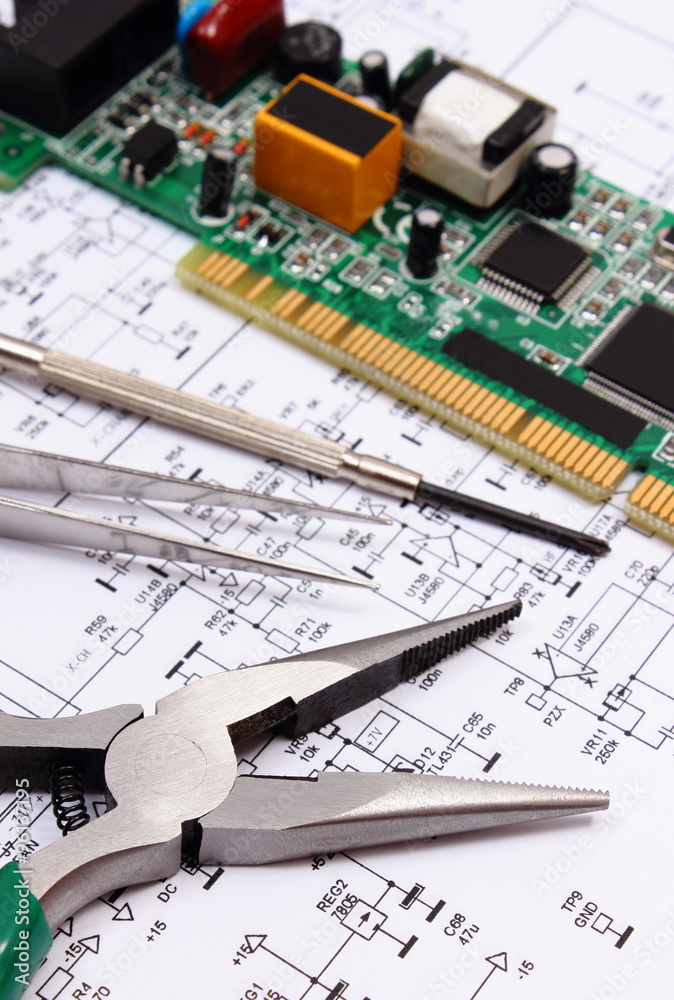 Printed circuit board and precision tools on diagram of electronics ...