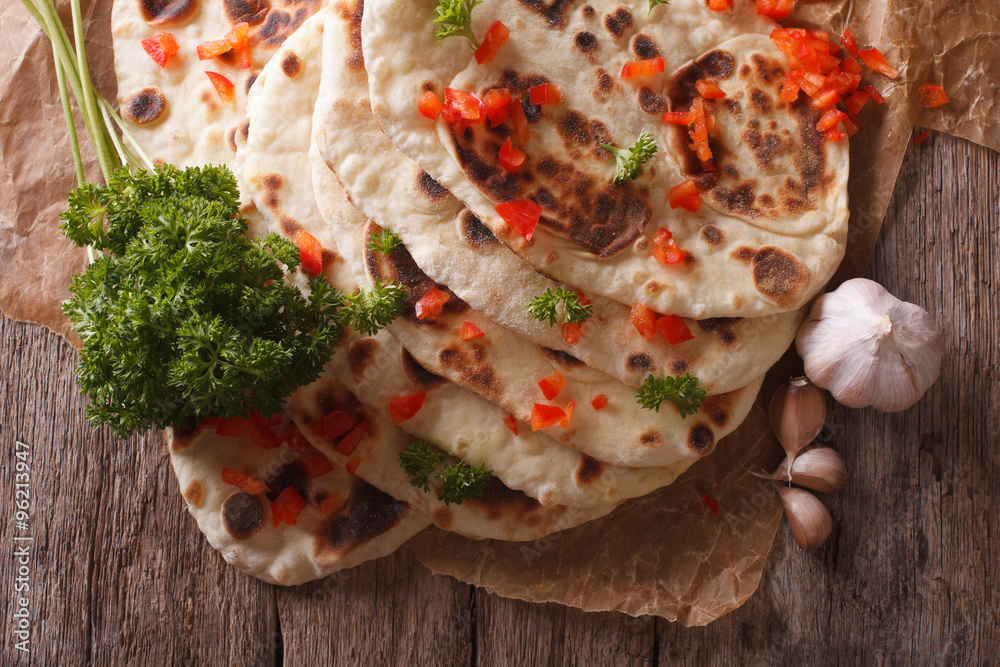 Indian Naan flat bread with garlic and herbs closeup. horizontal top ...