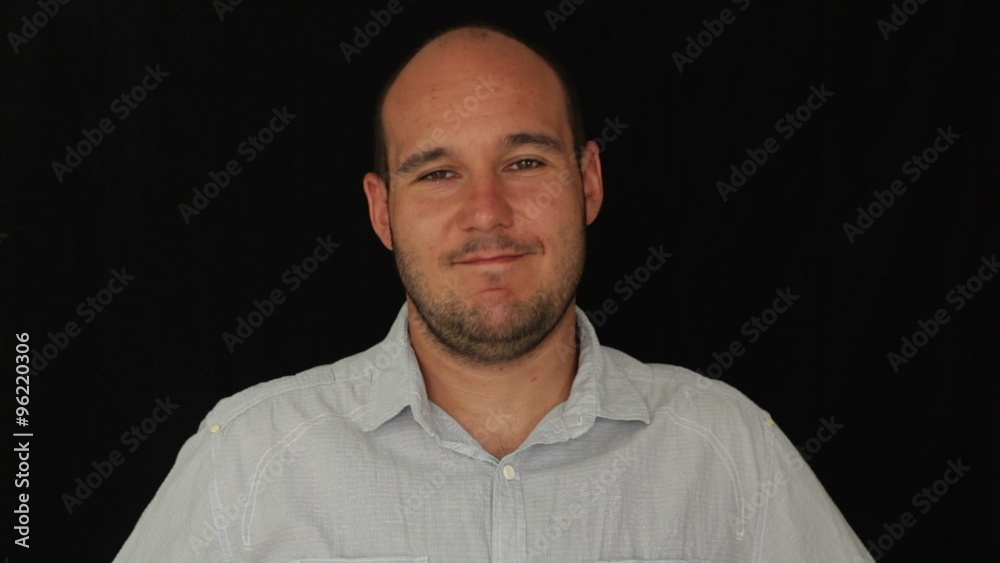 Positive man nodding his head, studio isolated on black background ...