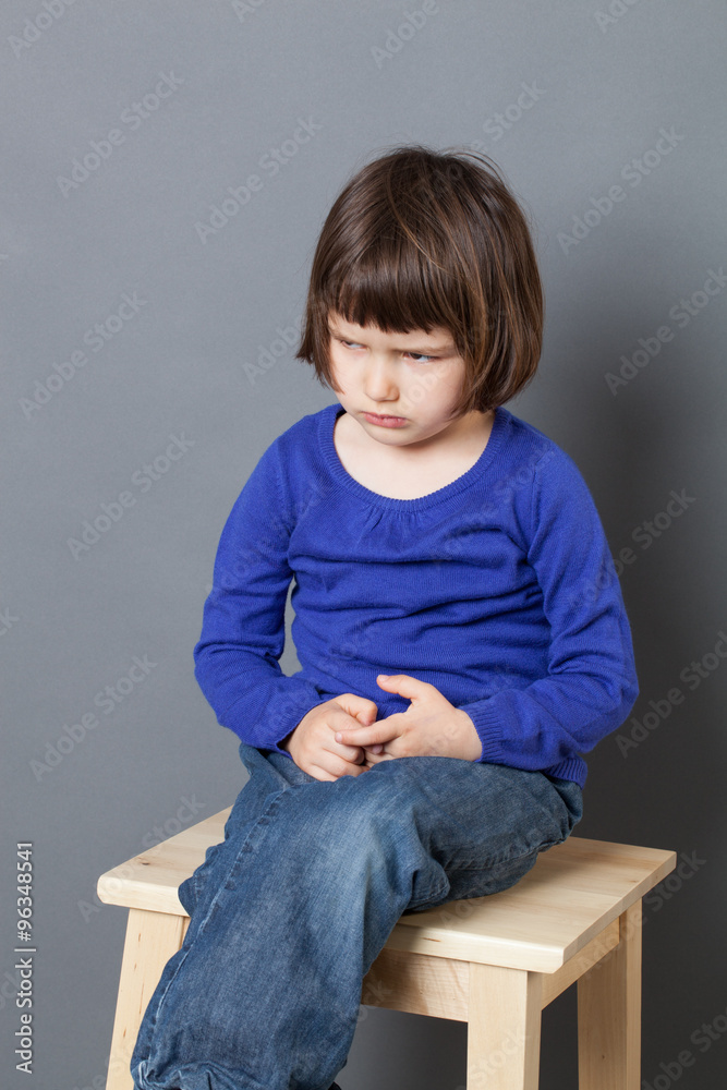 kid attitude concept - moody 4-year old child sulking on a stool for ...