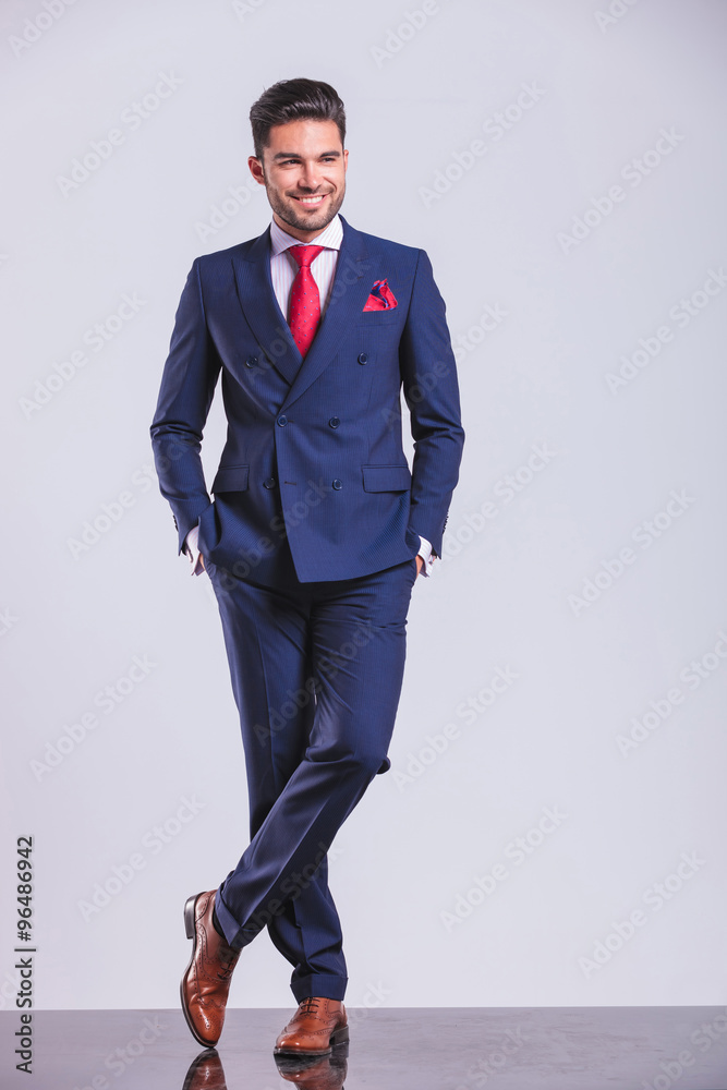 man in suit posing legs crossed while having hands in pockets Stock ...